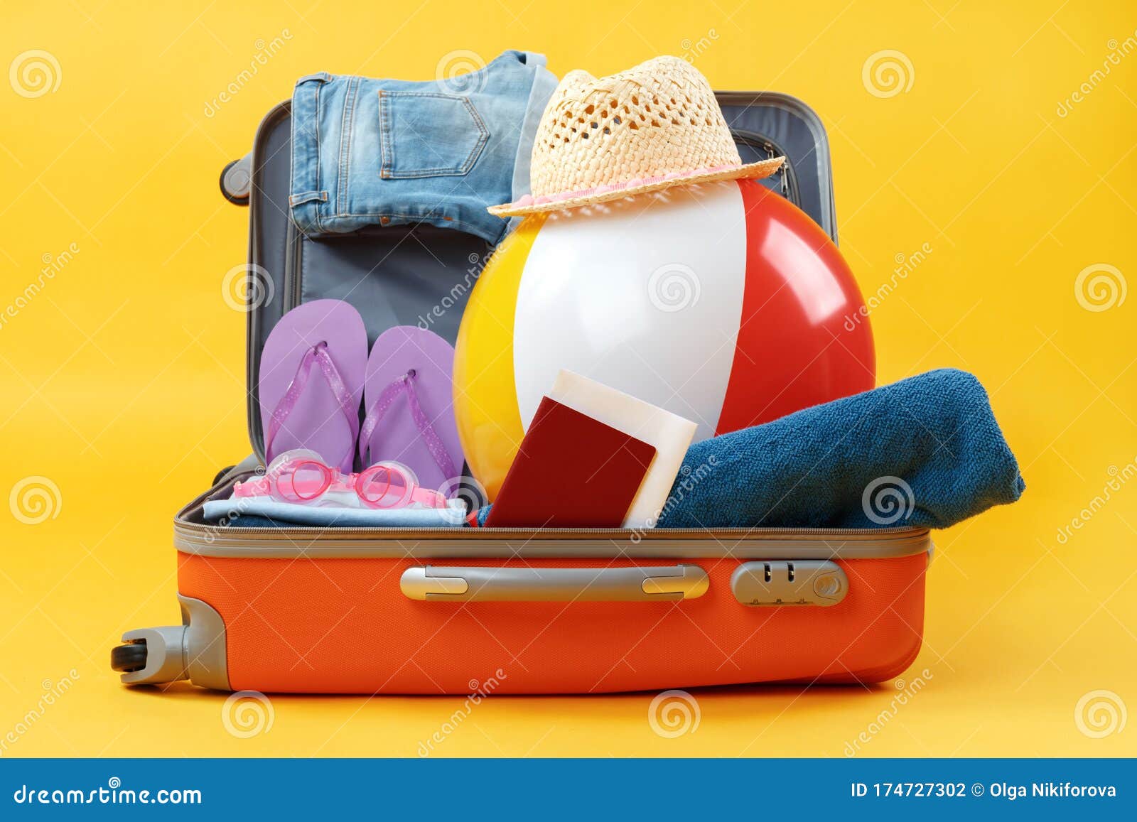 Open Full Suitcase with Items for Relaxation on a Yellow Background ...