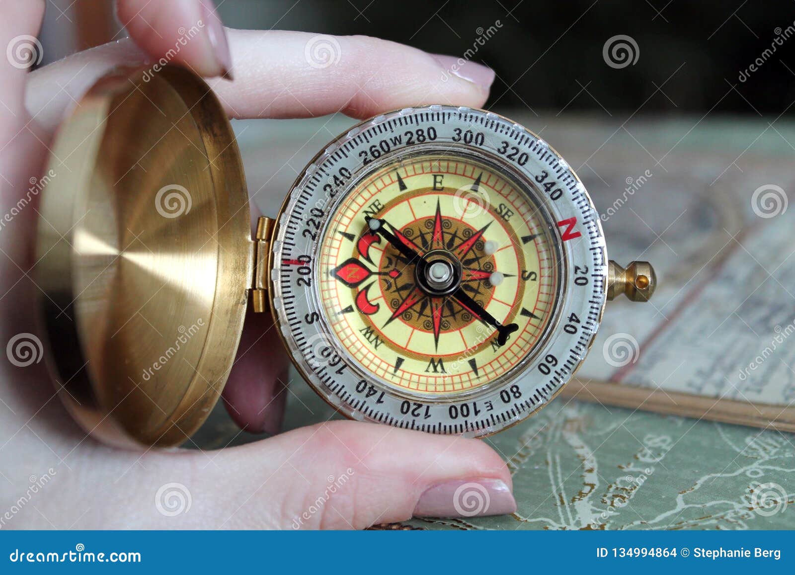 Gold Modern Compass on an Old Map Book Stock Photo - Image of east ...