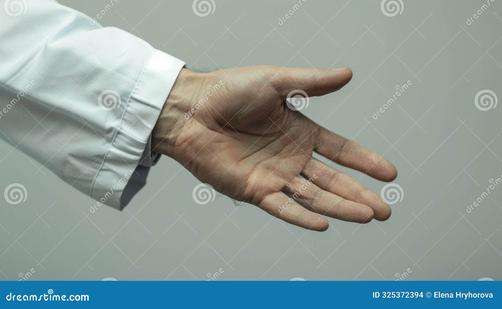 An Open Hand in a White Sleeve Reaching Out on a Light Background ...