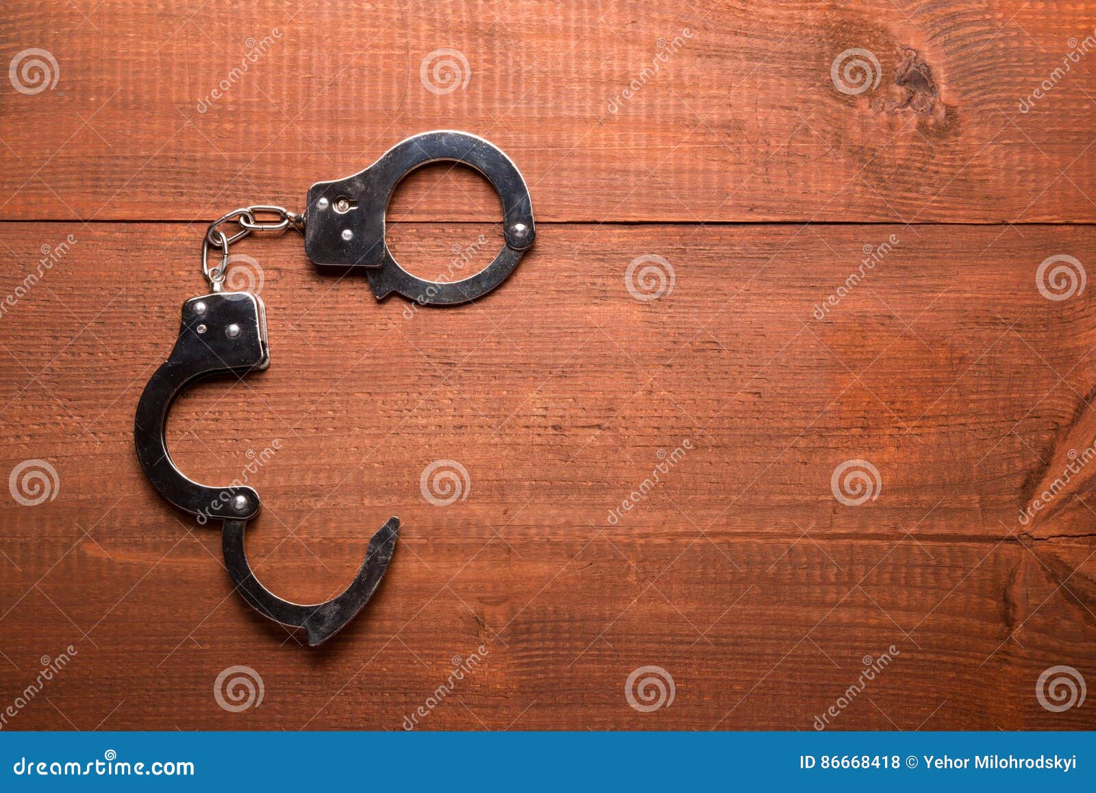 Open Handcuffs on a Wooden Table Stock Photo - Image of bondage ...
