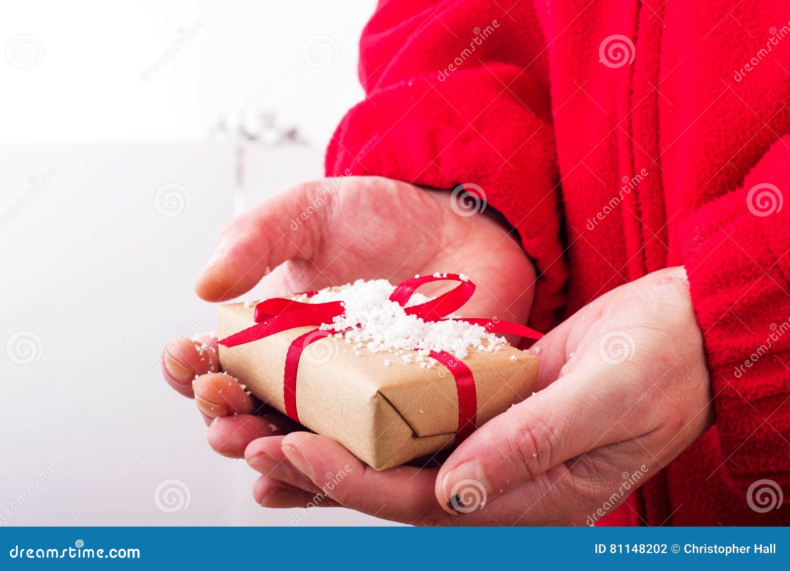Open Hands Holding a Present Wrapped with a Red Ribbon Stock Photo ...