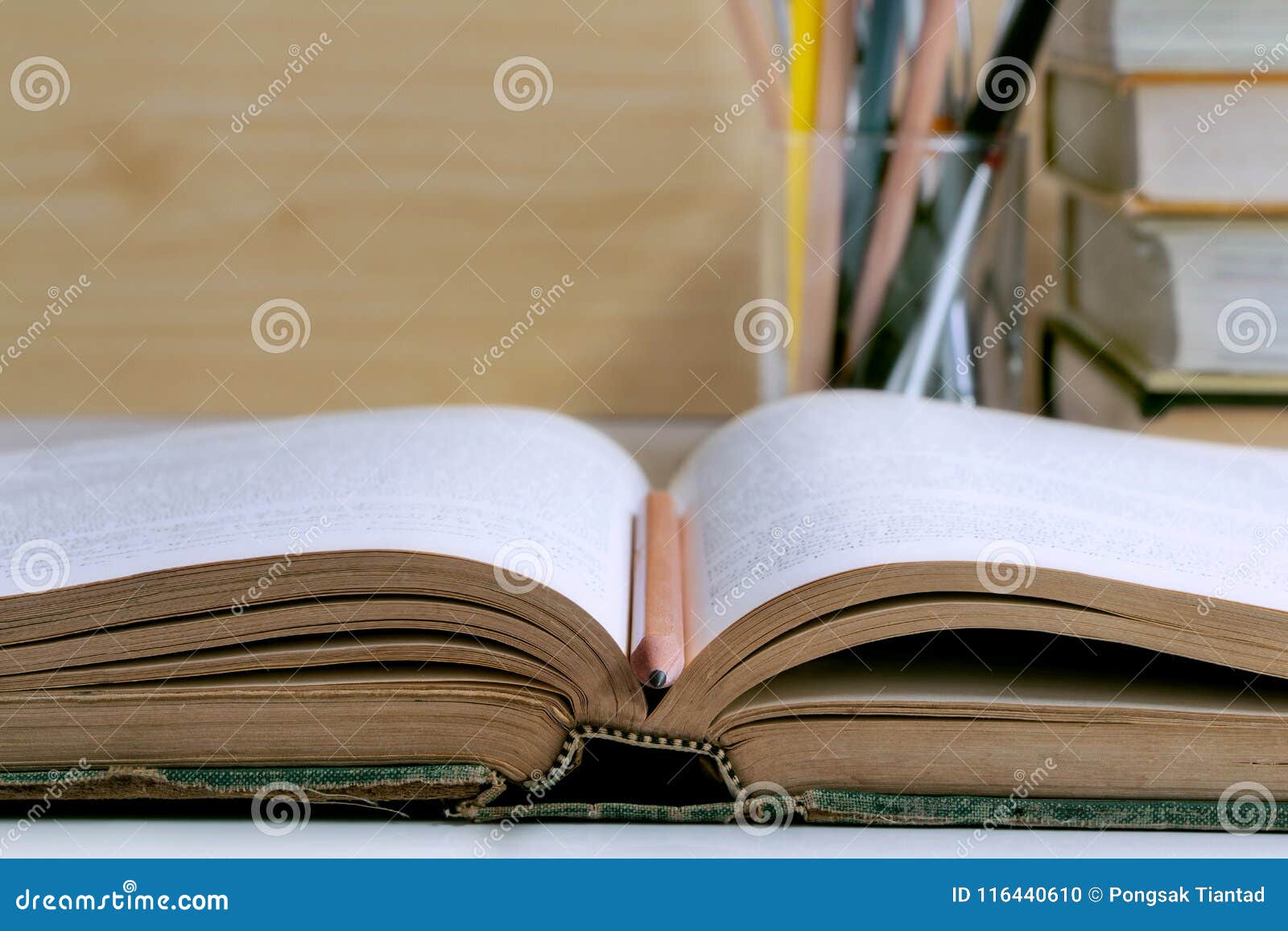 Open Hardback and Textbook Stacked on the Table Background. Stock Photo ...