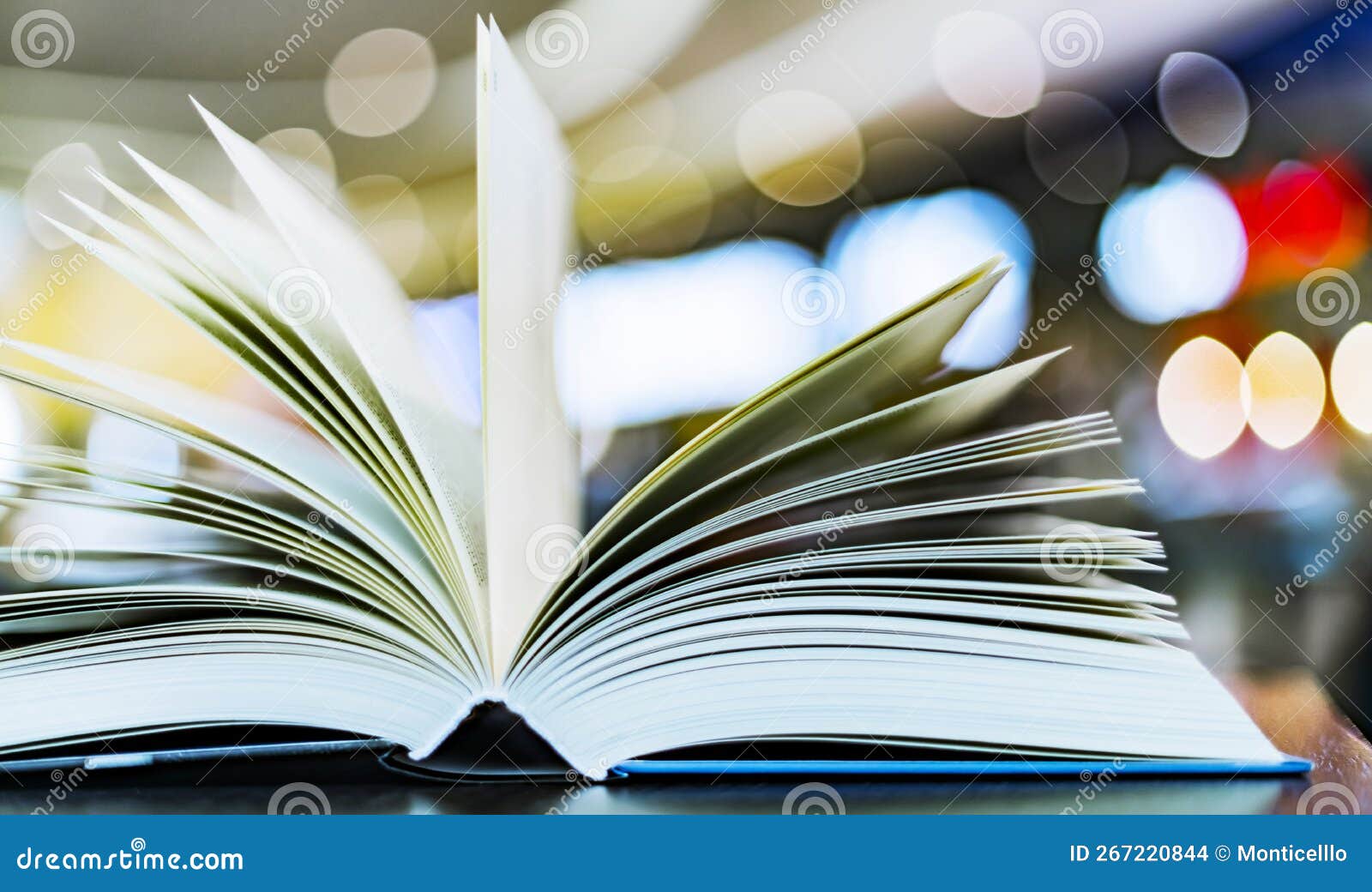 An Open Hardcover Book on a Table in a Public Library Stock Photo ...