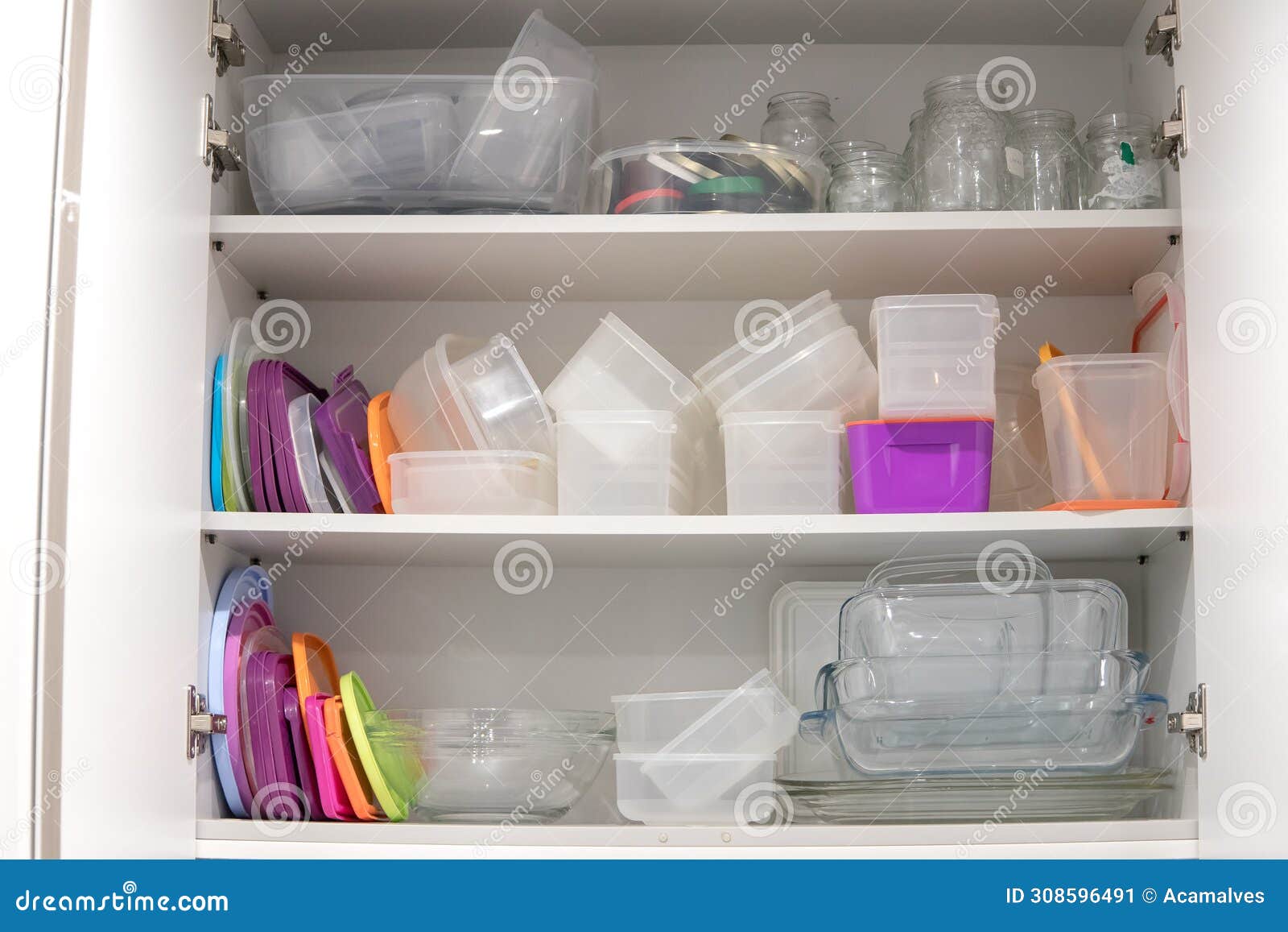 Open Kitchen Cupboard Full of Plastic and Glass Containers Inside ...