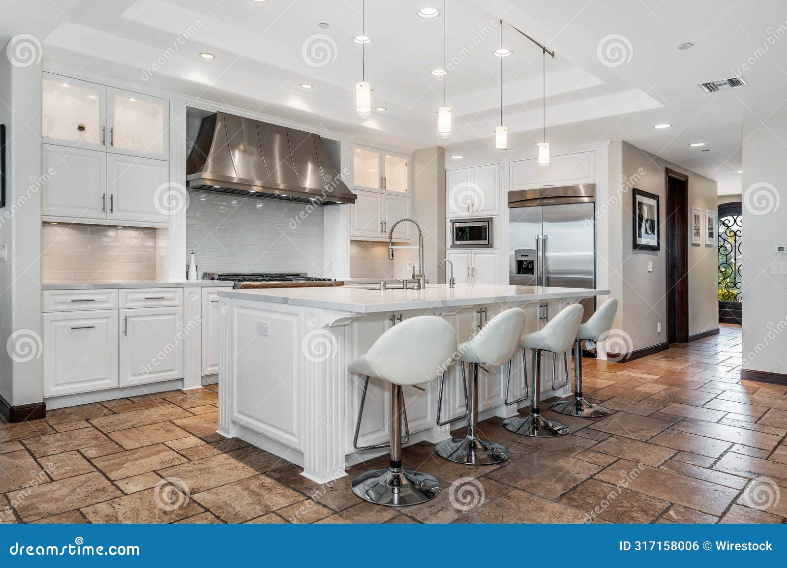 An Open Kitchen with Four Bars and Stools in it Stock Photo - Image of ...