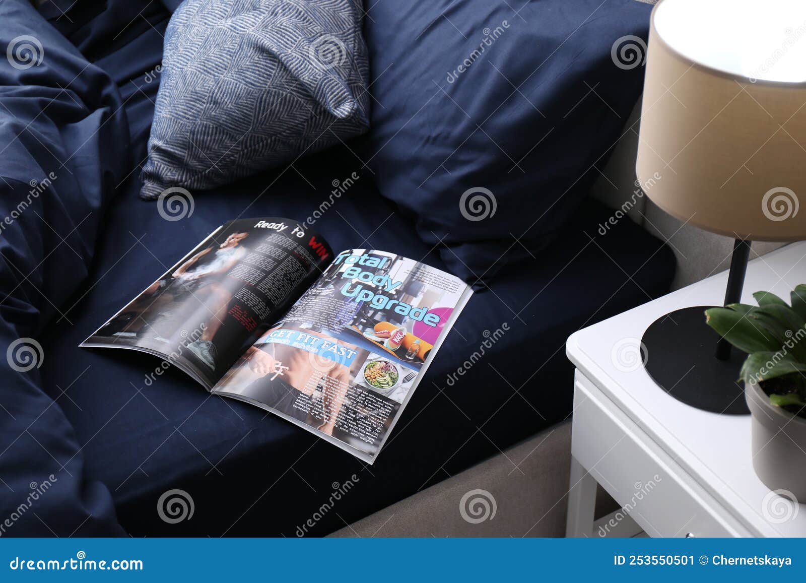Open Magazine on Bed with Stylish Silky Linens Stock Image - Image of ...