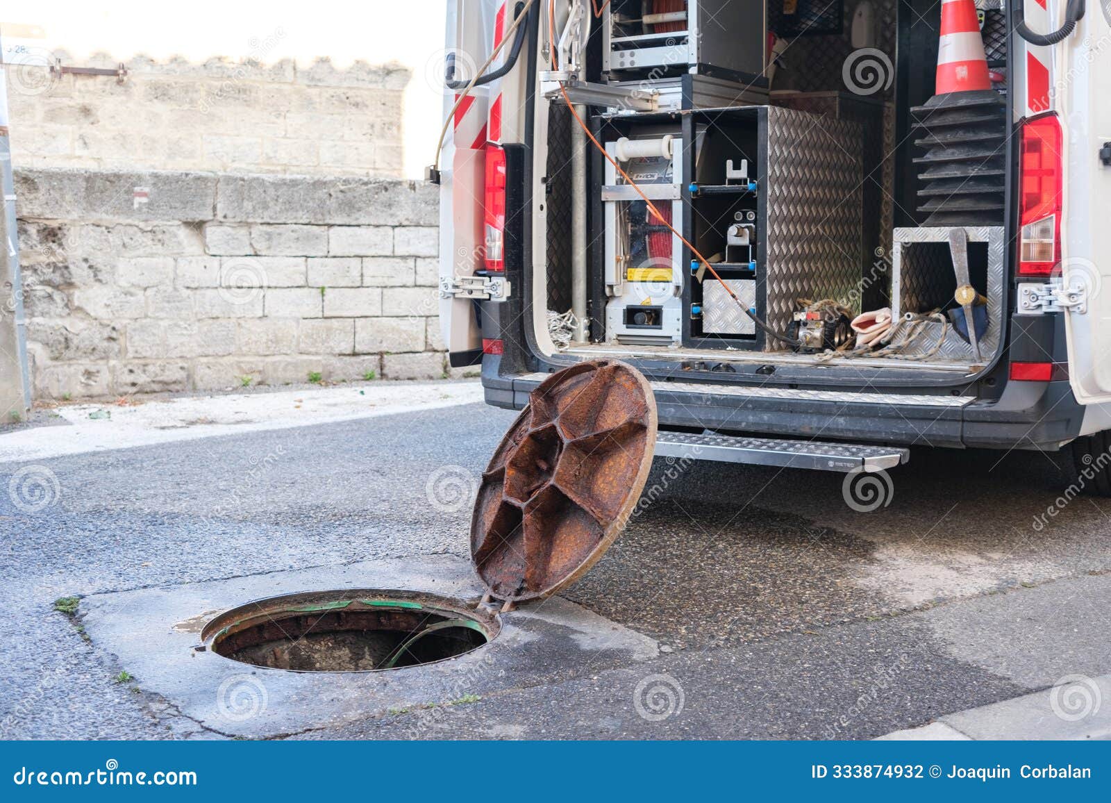 Open Manhole Cover and Workers with Repair Tools Stock Photo - Image of ...
