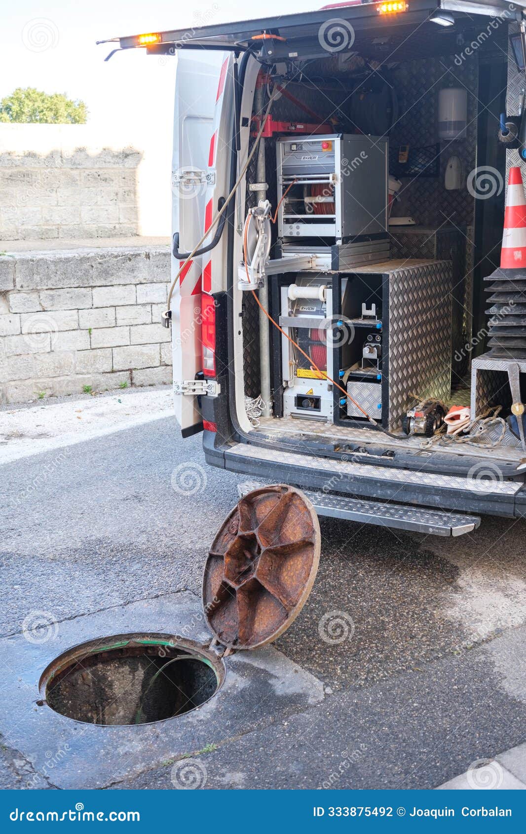 Open Manhole Cover and Workers with Repair Tools Stock Photo - Image of ...