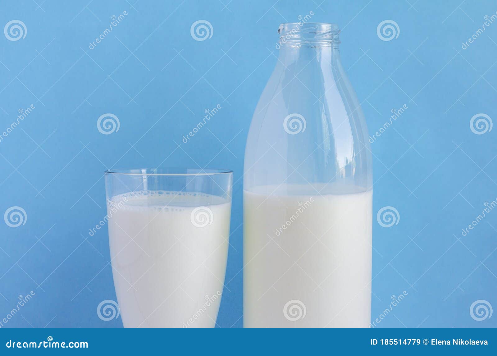 An Open Milk Bottle and a Glass of Milk on a Blue Background Stock ...