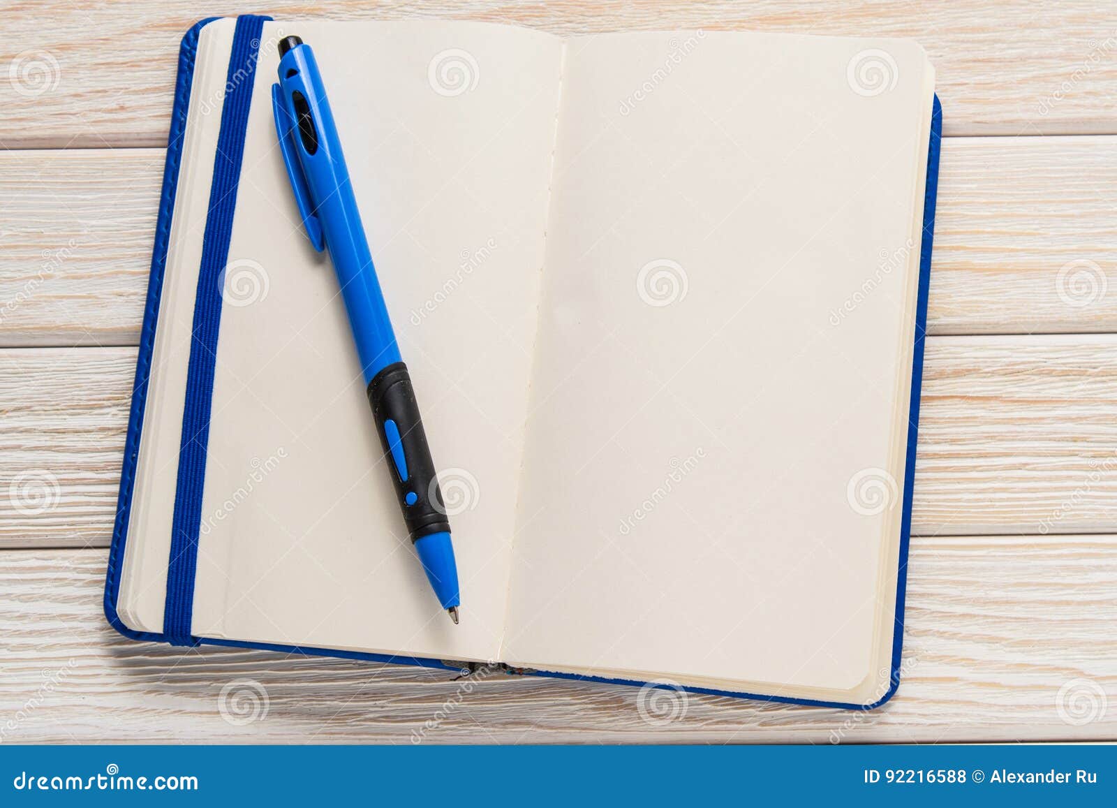 Open Notebook with Blue Cover and Pen on a Wooden Background Stock ...