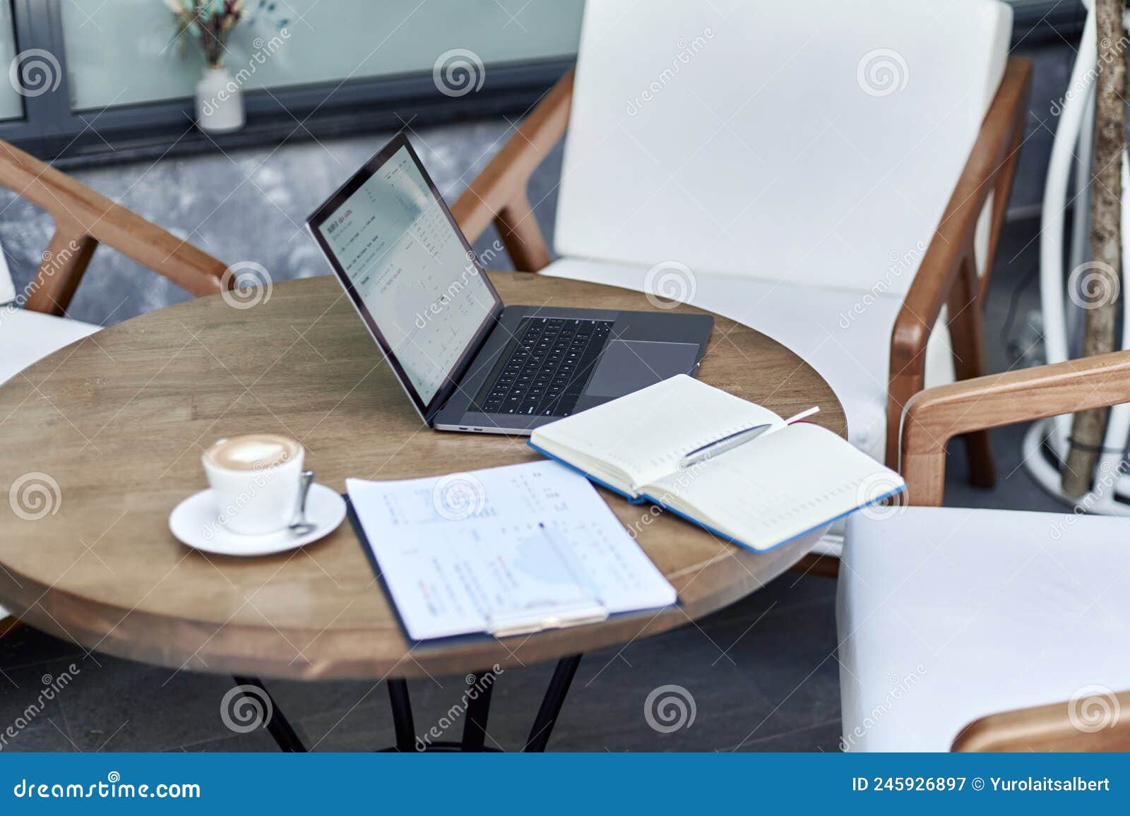 Open Notebook and a Laptop on the Table in an Internet Cafe. Stock ...
