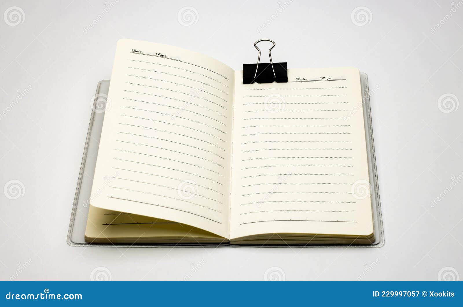 Open Notebook on White Background with an Attached Black Binder Clip ...