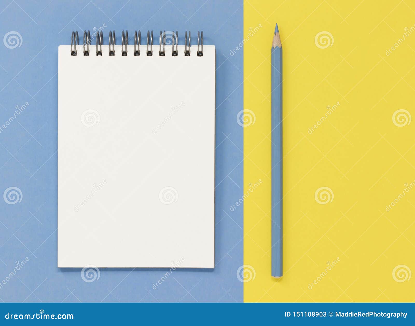 Open Notepad With A Blue Gray Pencil, On A Blue-gray And Yellow Flat ...