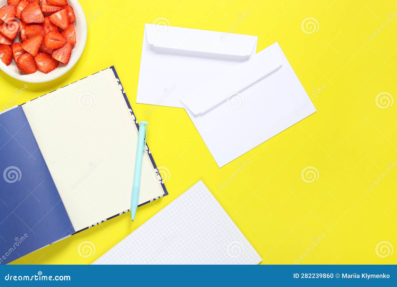 The Notepad And Letter Envelope Are On A Bright Yellow Background Stock ...