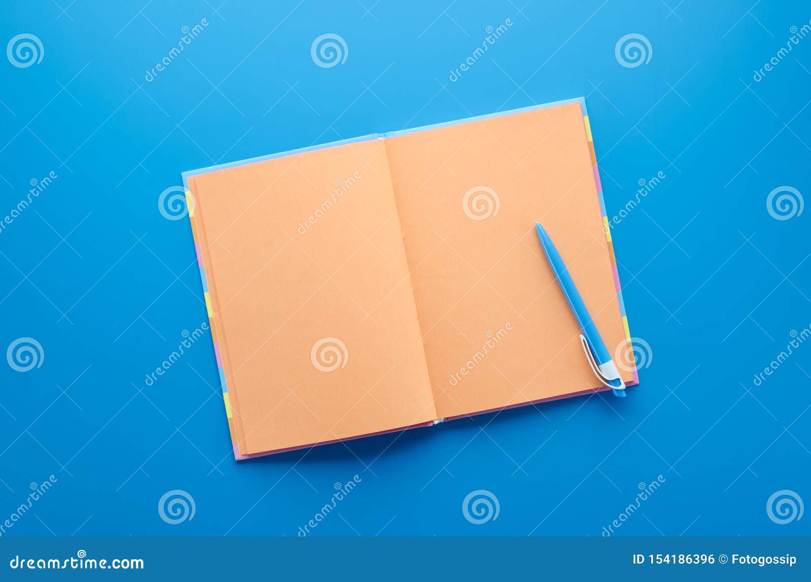 Open Orange Notebook with Blue Pens on Blue Background Stock Photo ...
