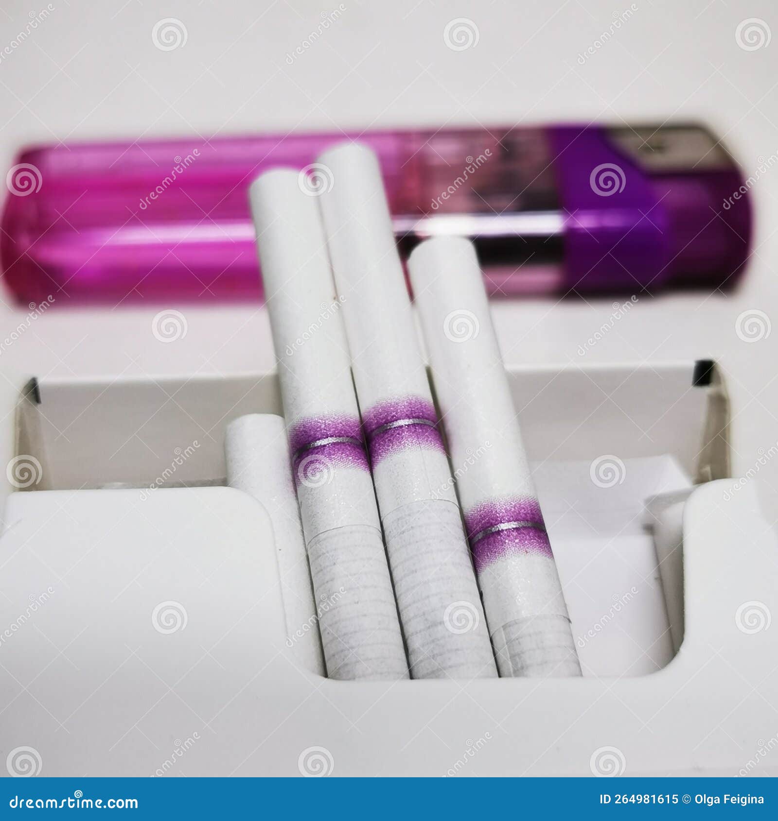 White Thin Cigarettes and a Purple Lighter on a White Background. Stock ...