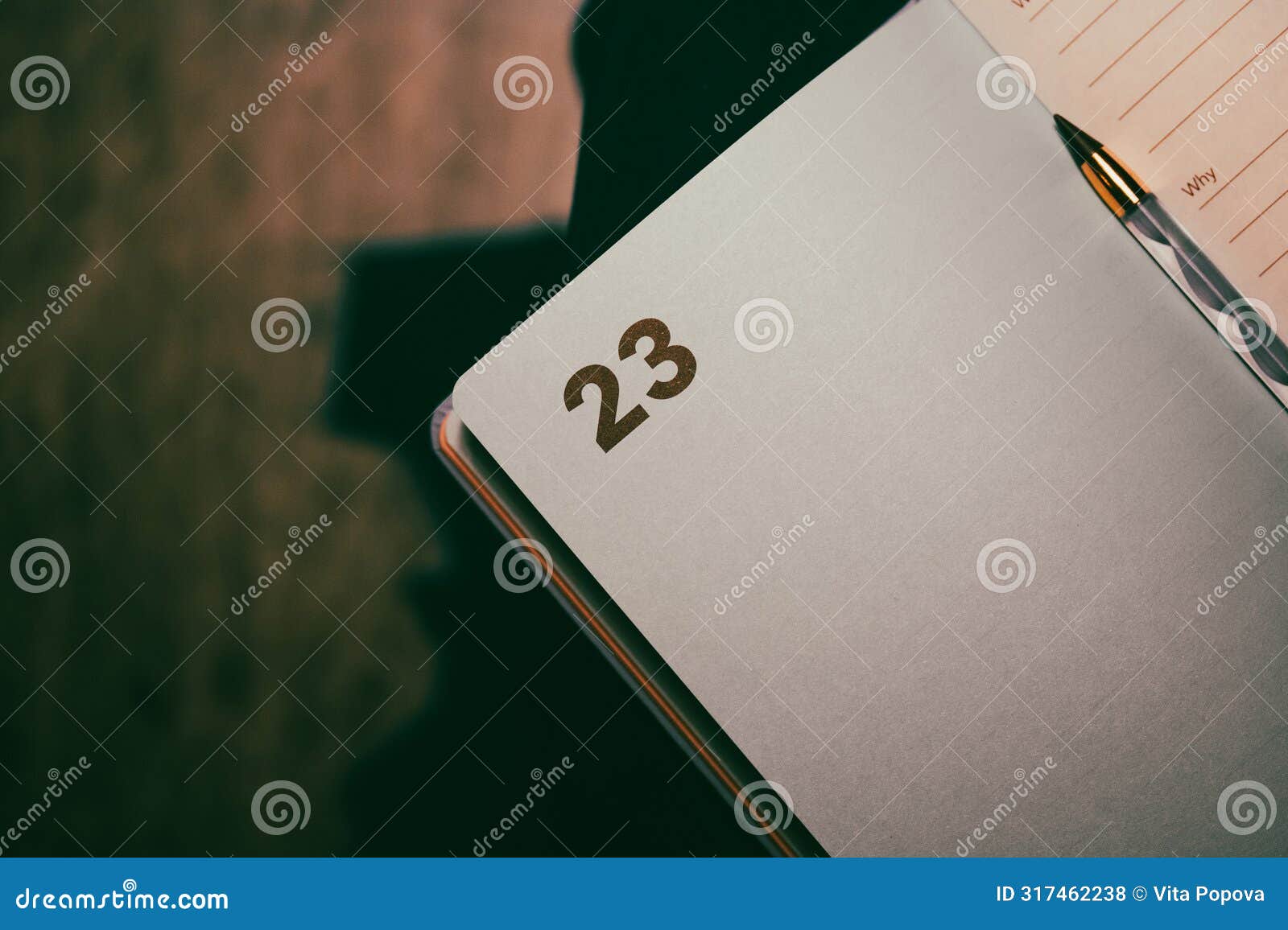 An Open Pad with a Date 23 is Lying on Dark Table Top View. a Notebook ...