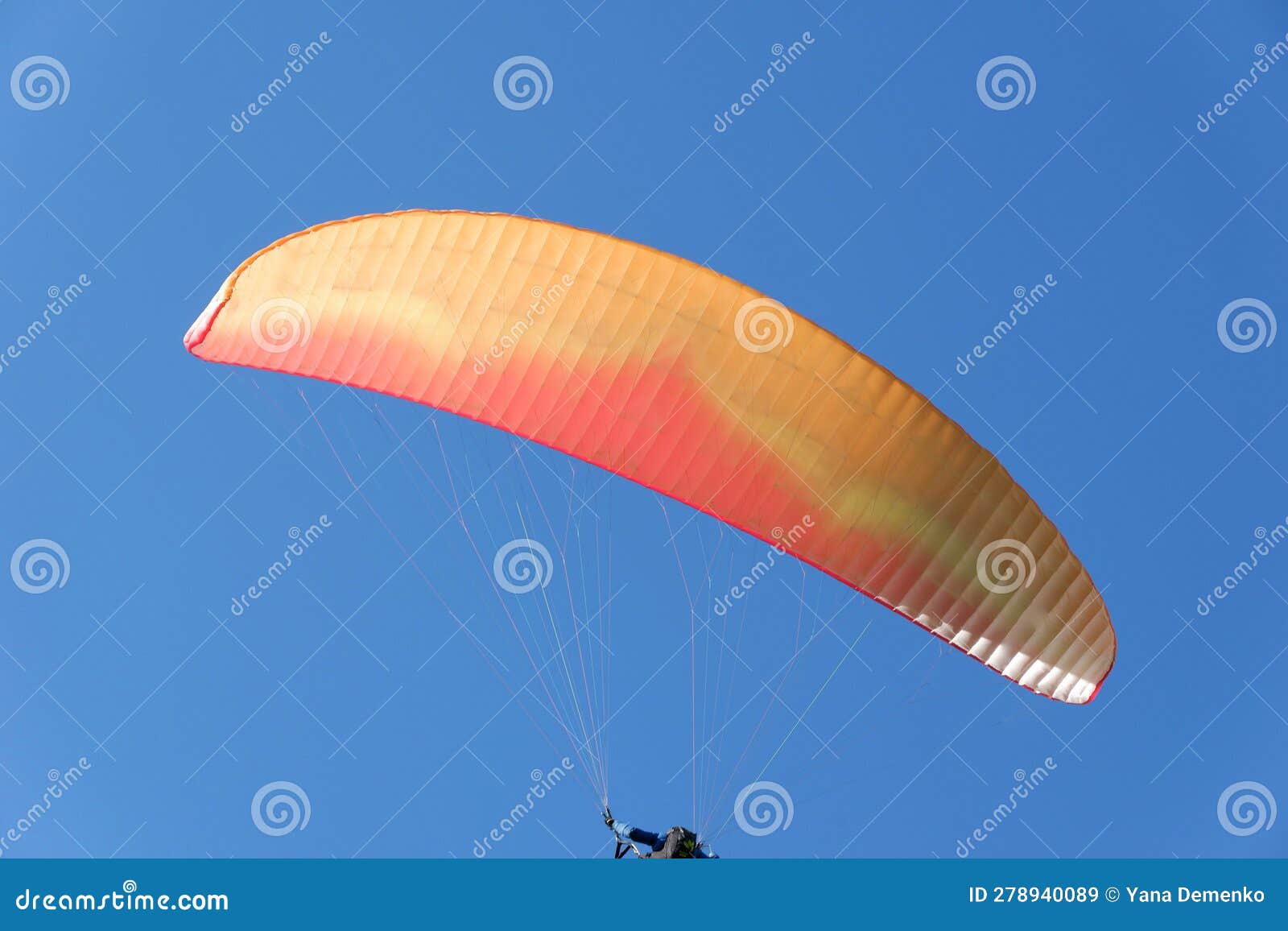 Open Paragliding Parachute of Yellow and Red Colour in the Bright Blue ...
