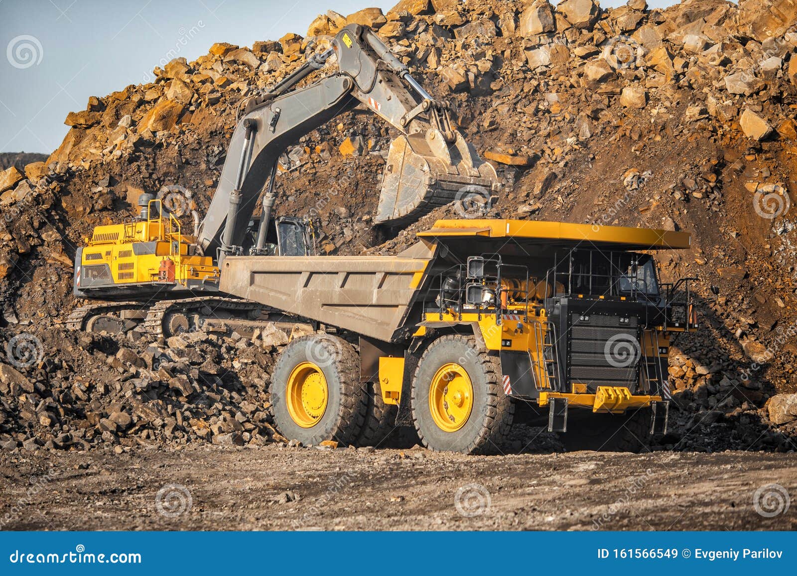 Open Pit Mine Industry, Excavator Loading Coal on Big Yellow Mining ...