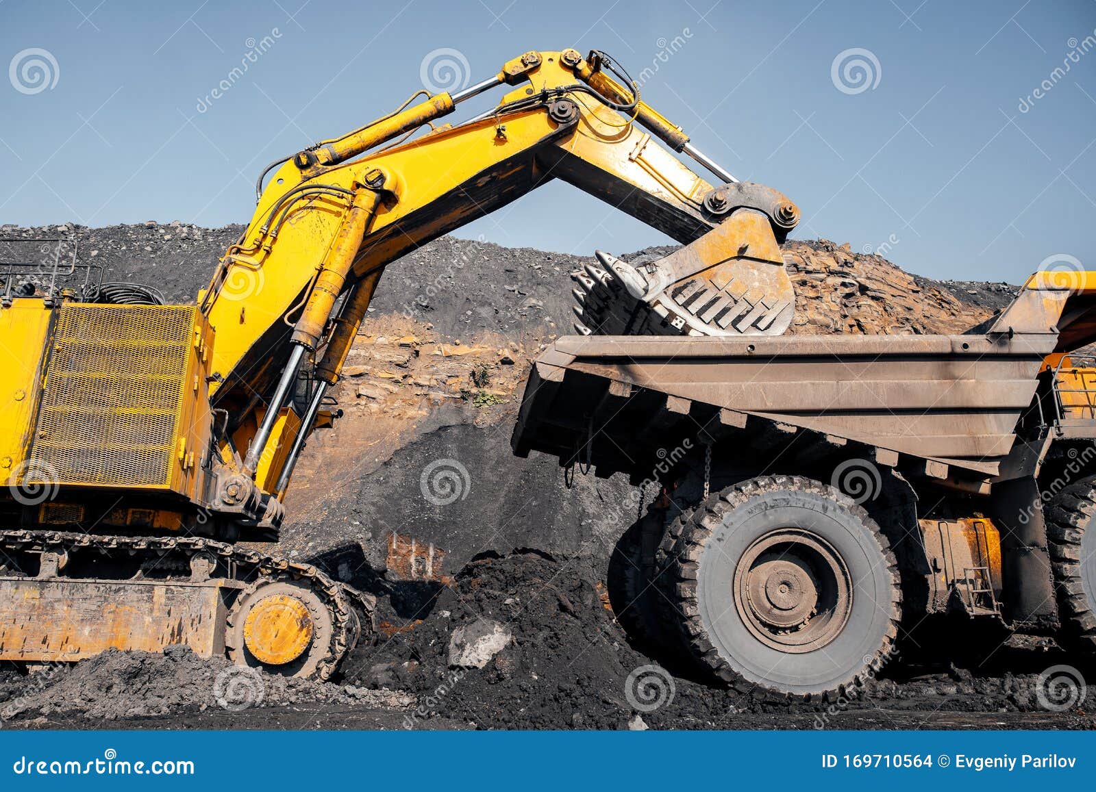 Open Pit Mine Industry, Excavator Loading Coal on Big Yellow Mining ...