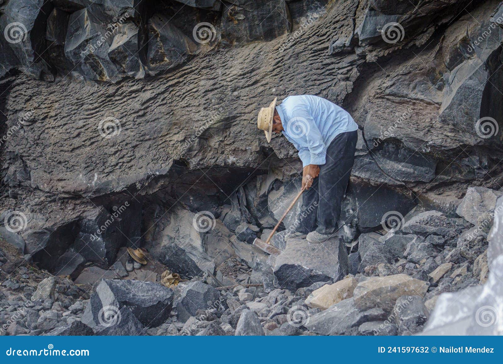 Man Breaking Volcanic Rock with Metal Hammer Stock Photo - Image of ...
