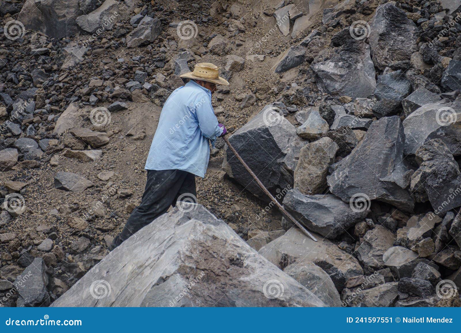 Man Using a Metal Bar To Pull the Volcanic Rock Stock Image - Image of ...