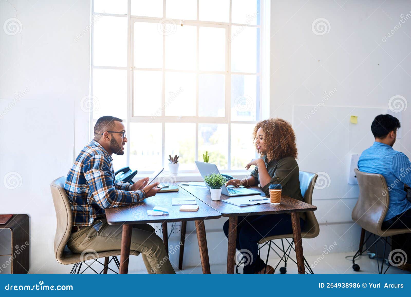 Open Plan Promotes Open Discussions. Two Young Coworkers Having a ...