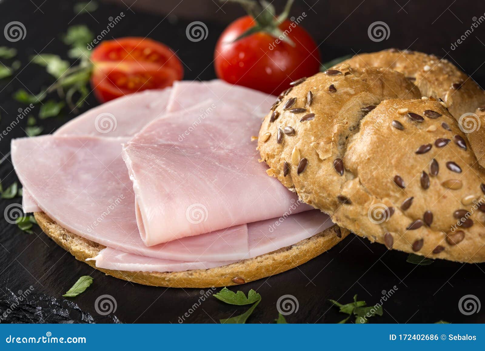 Open Sandwich with Sliced Ham on a Dark Slate with Herbs Stock Photo ...