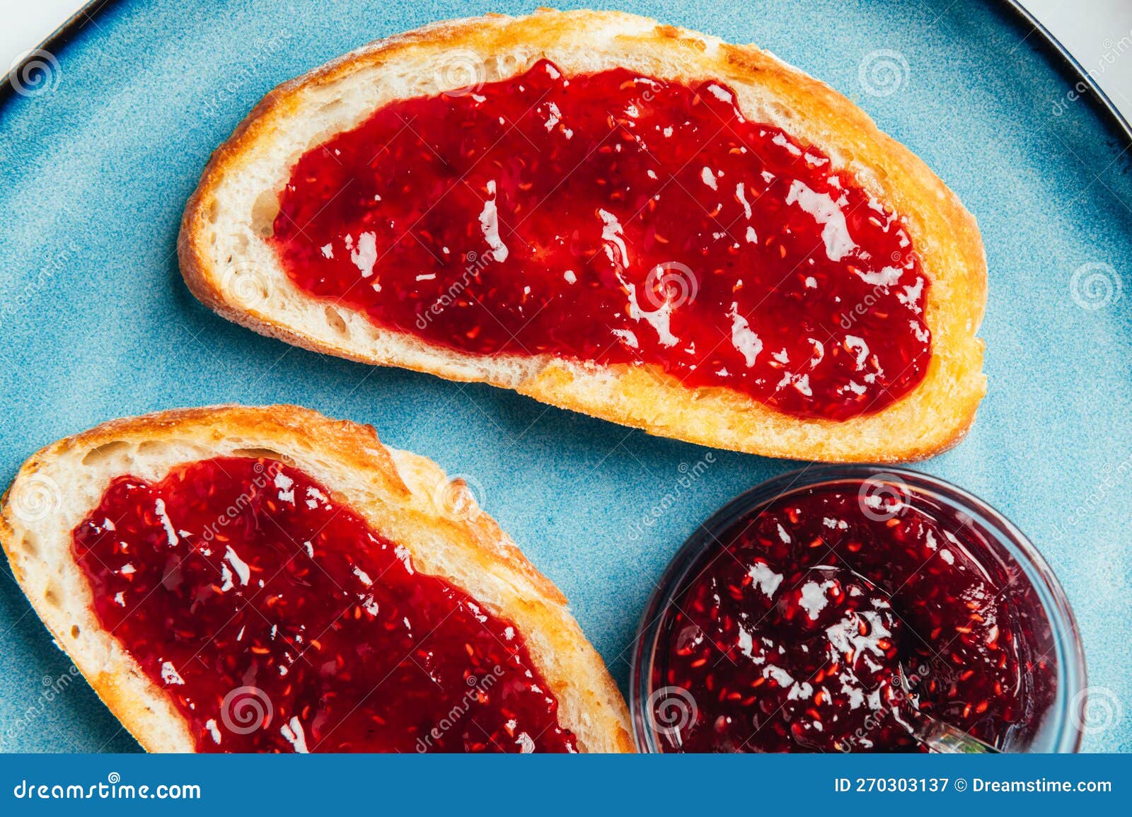 Raspberry jam on toast stock image. Image of eating - 270303137