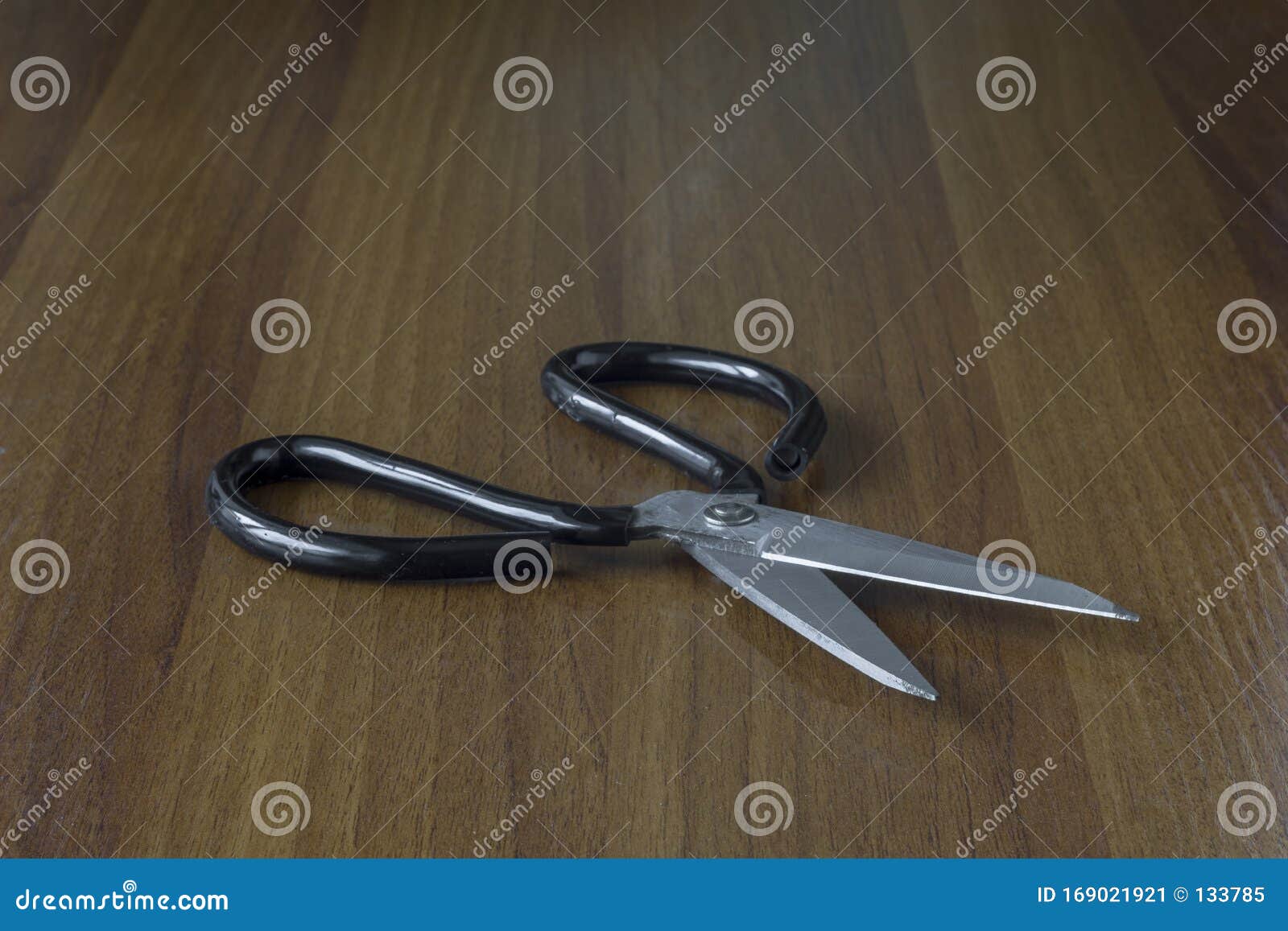 Open Scissors on a Yellow Wooden Table Surface Stock Image - Image of ...