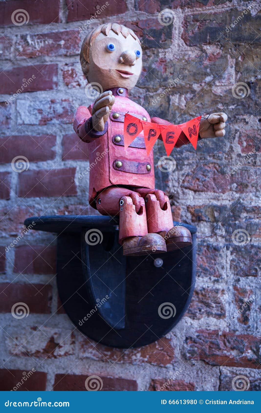 Open Sign; German Boy Figurine on a Brick Wall Stock Photo - Image of ...