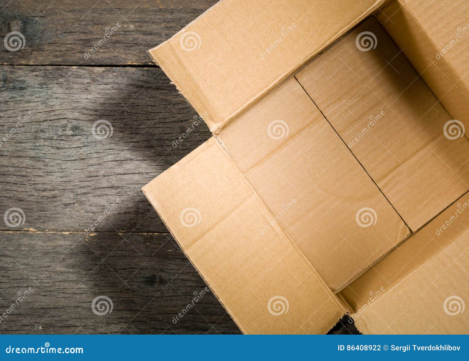 Open Square Cardboard Box on the Background of the Old Wooden Table ...