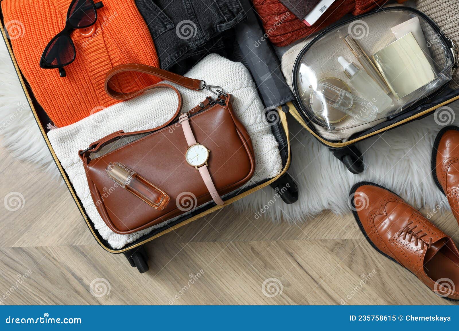 Open Suitcase with Folded Clothes, Accessories and Shoes on Floor, Flat ...