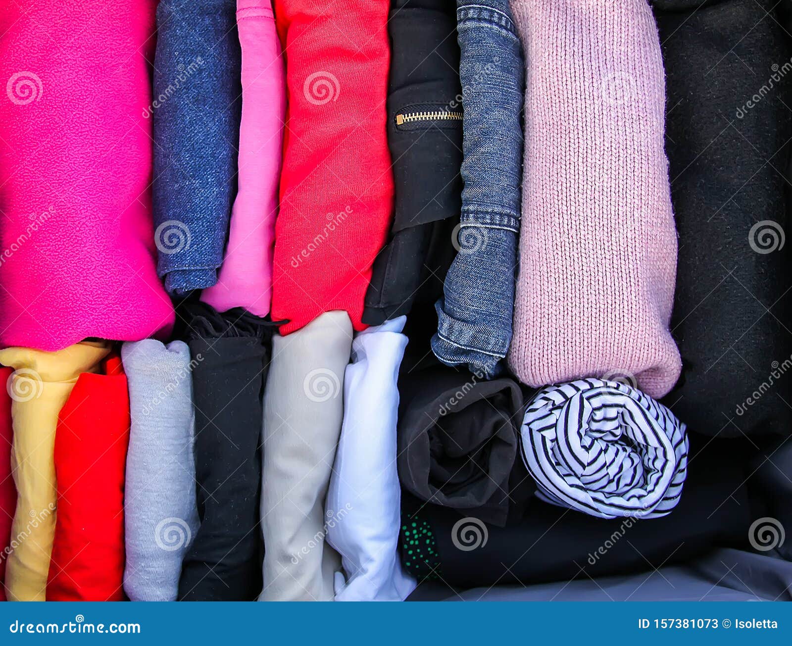 Open Suitcase On The Green Grass With Different Clothes Folded ...