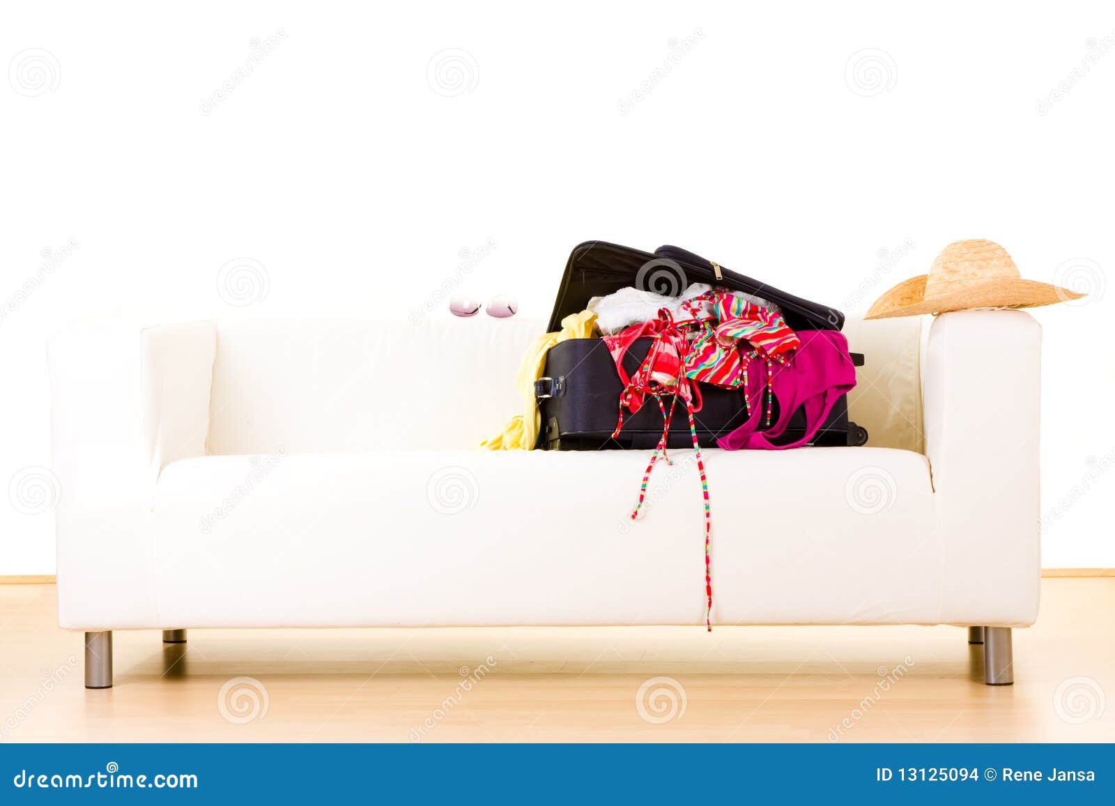 Open Suitcase On The Green Grass With Different Clothes Folded ...