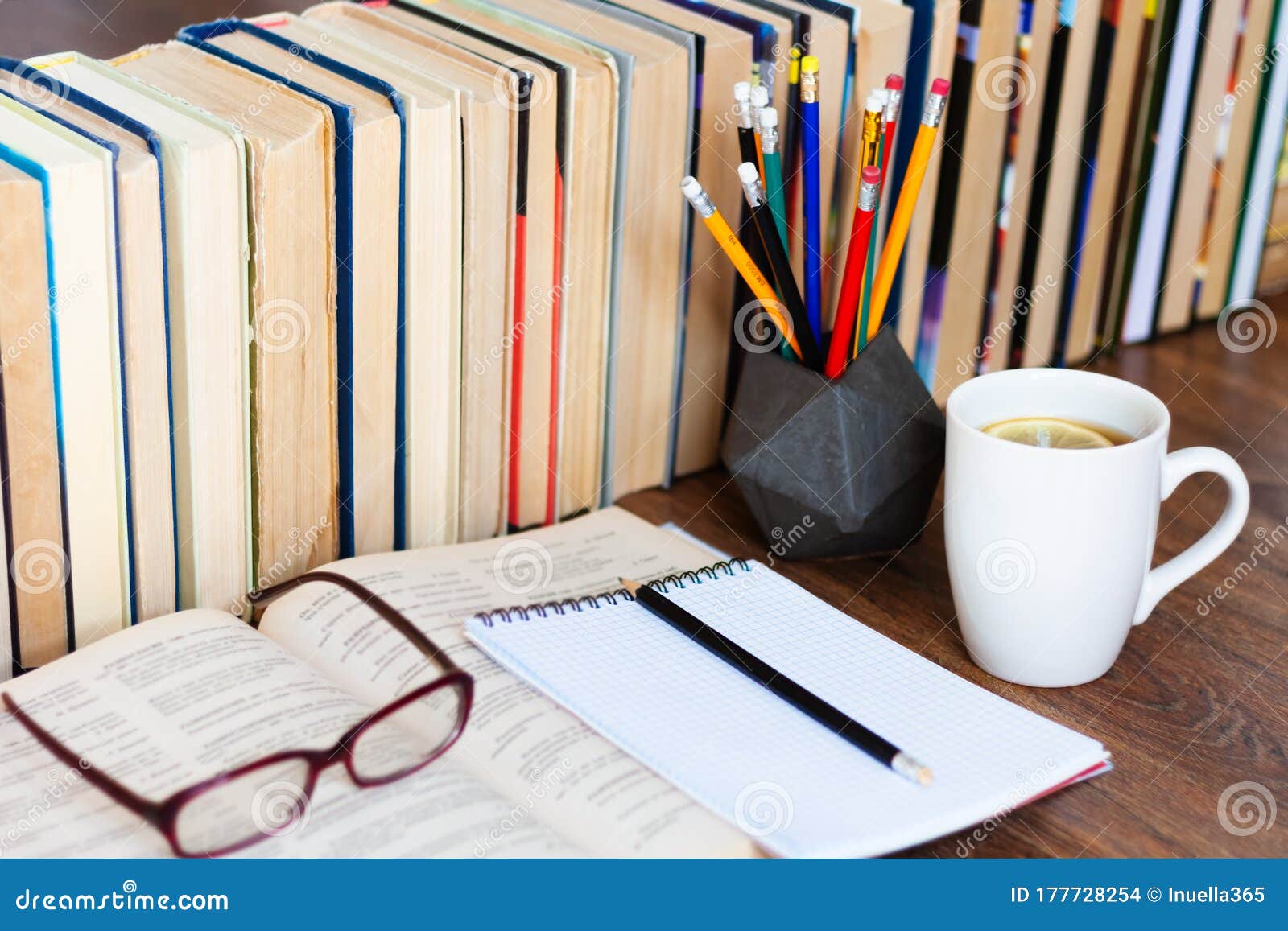 Open Textbook, Notebook, Glasses, Pencils in Holder, Cup of Tea and ...