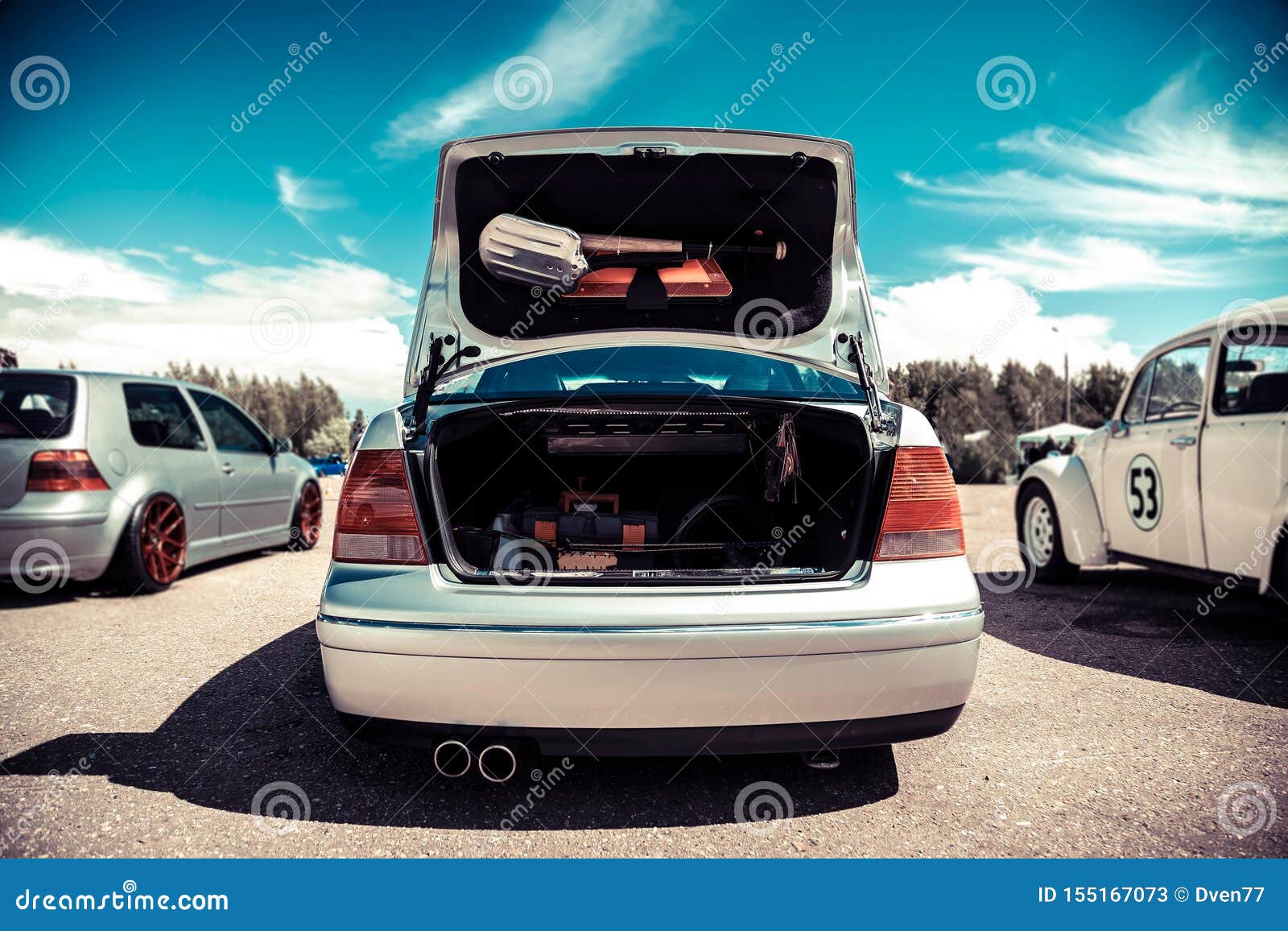 Open The Trunk Of A Silver Car That Stands On The Street. In The Trunk ...