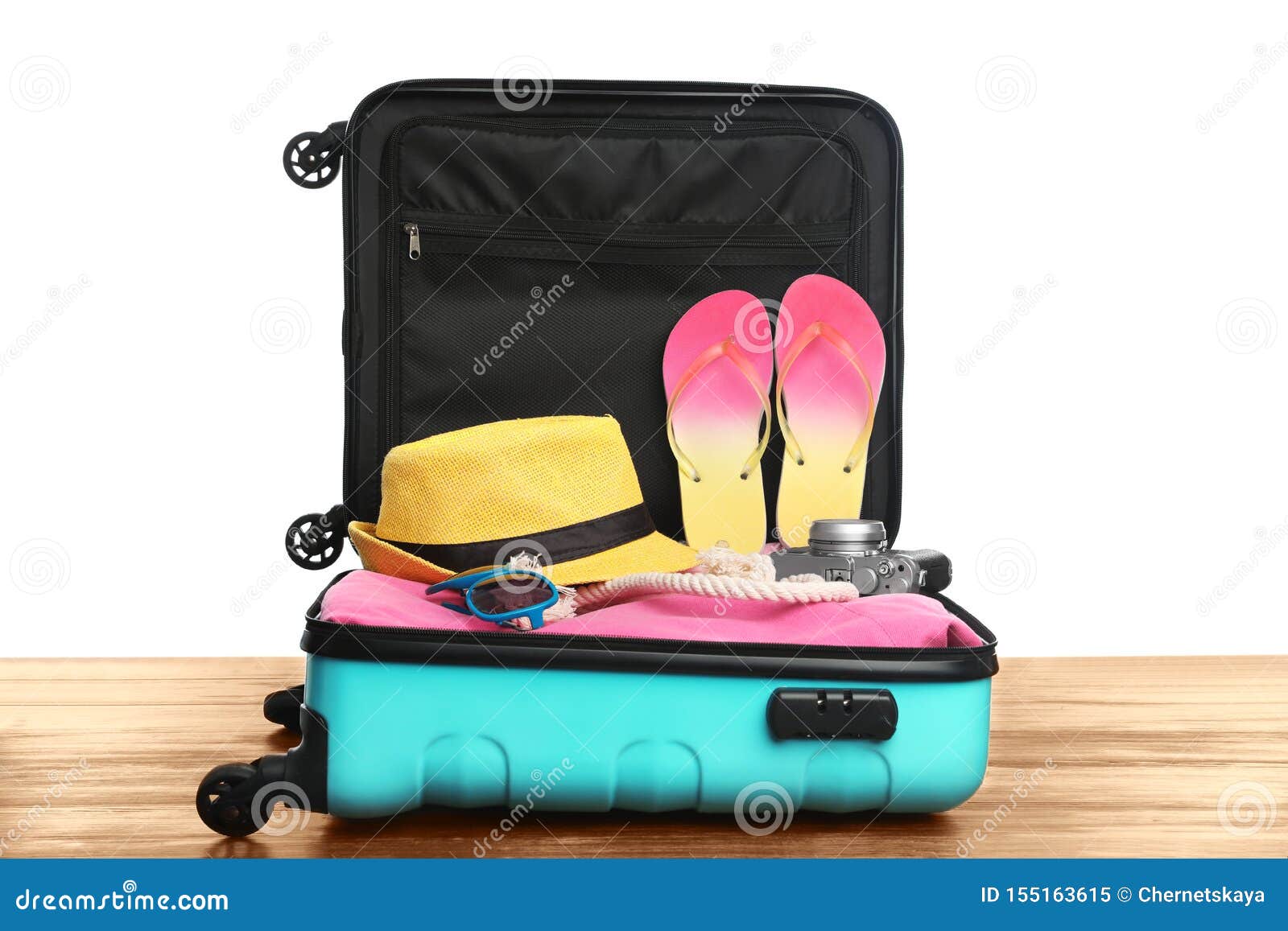 Open Turquoise Suitcase with Beach Objects on Wooden Table, White ...