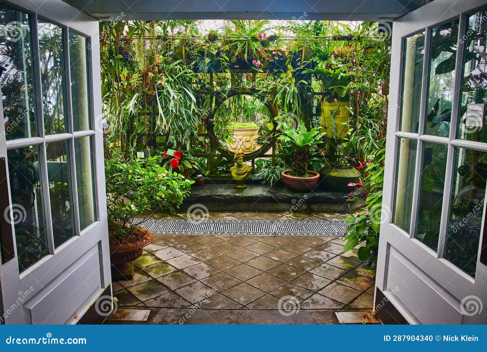 Open White Doors Leading To Moon Gate Inside Trellis Covered in Plants ...