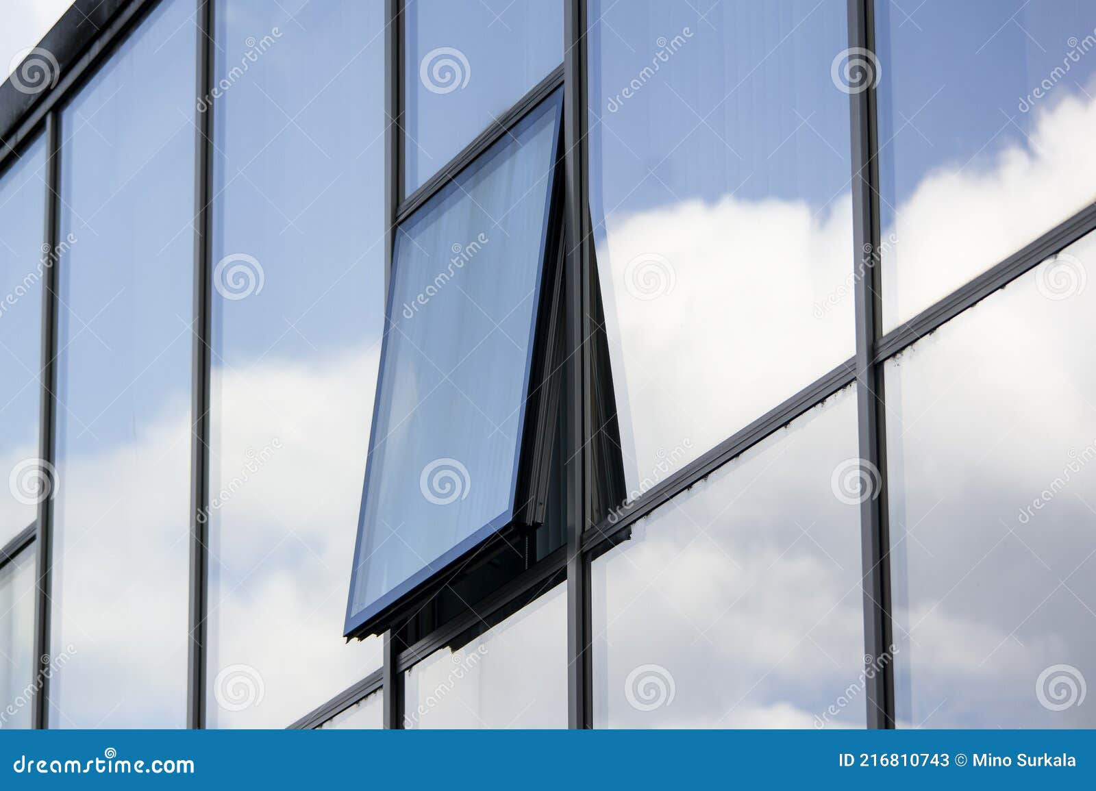 The Open Window on a Commercial Building with a Blue Cloudy Sky ...