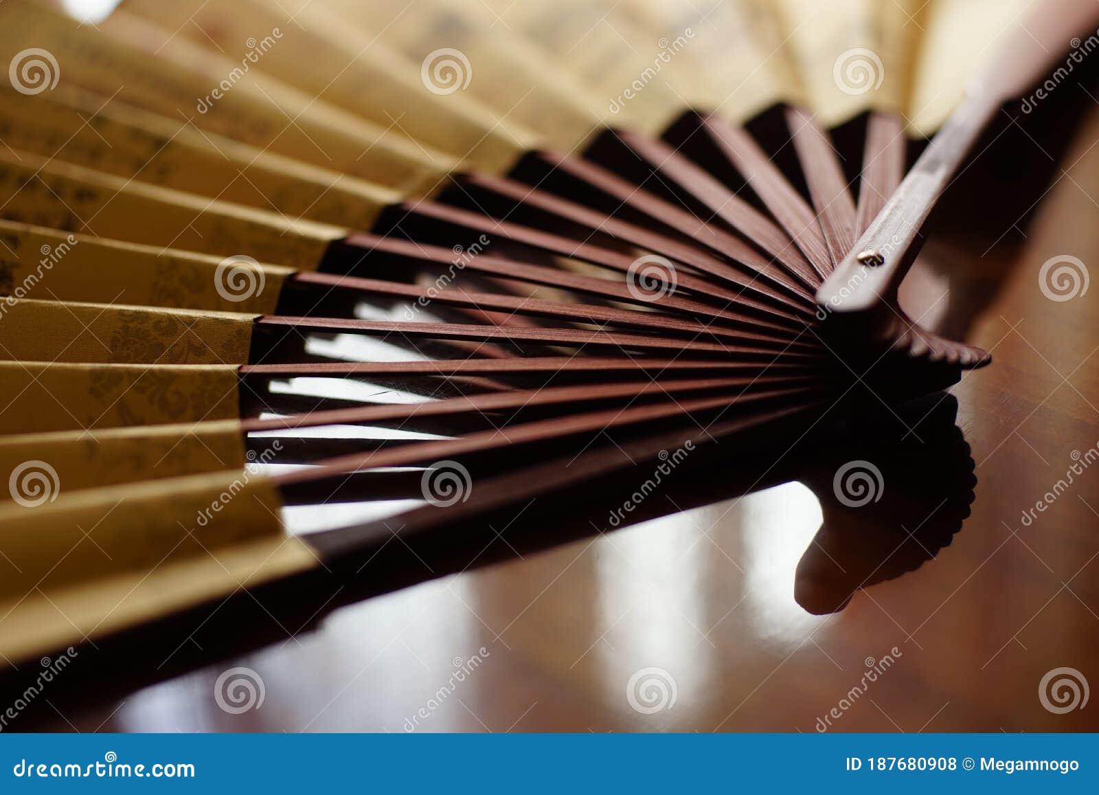 Open Yellow Fan with Brown Chinese Characters on the Table, Closeup ...