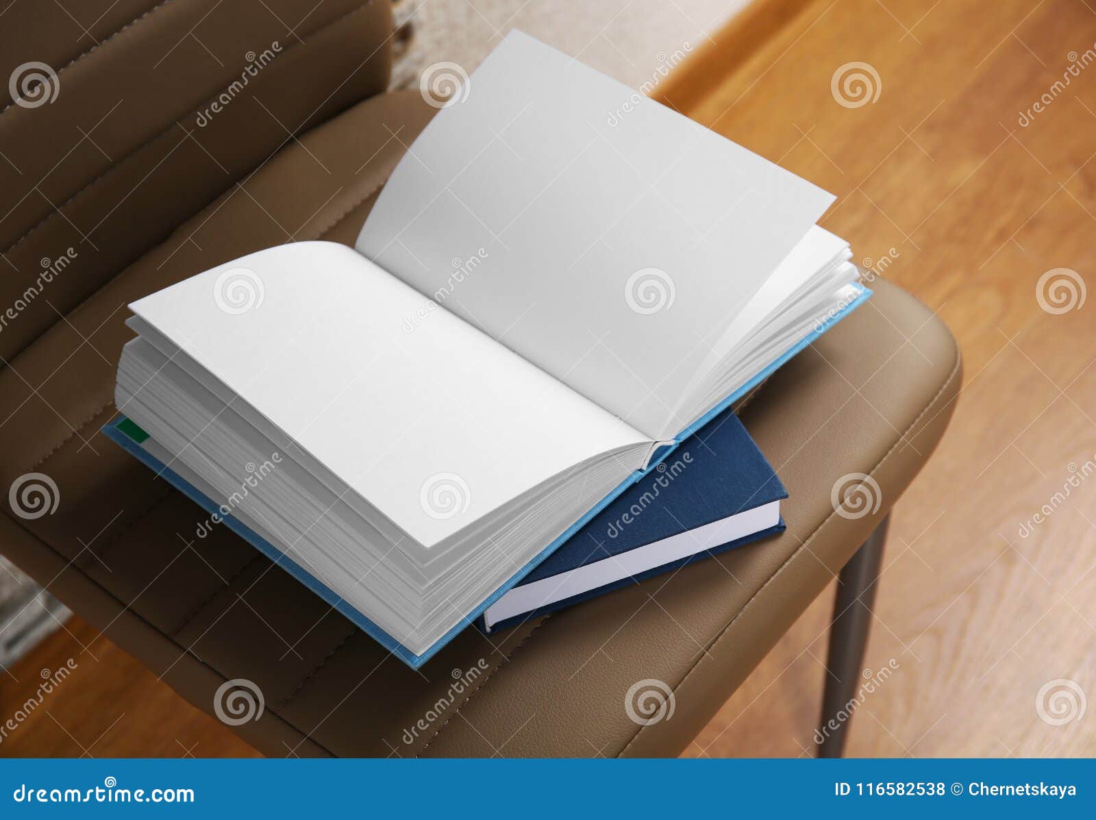 Opened book on chair stock photo. Image of modern, chair - 116582538