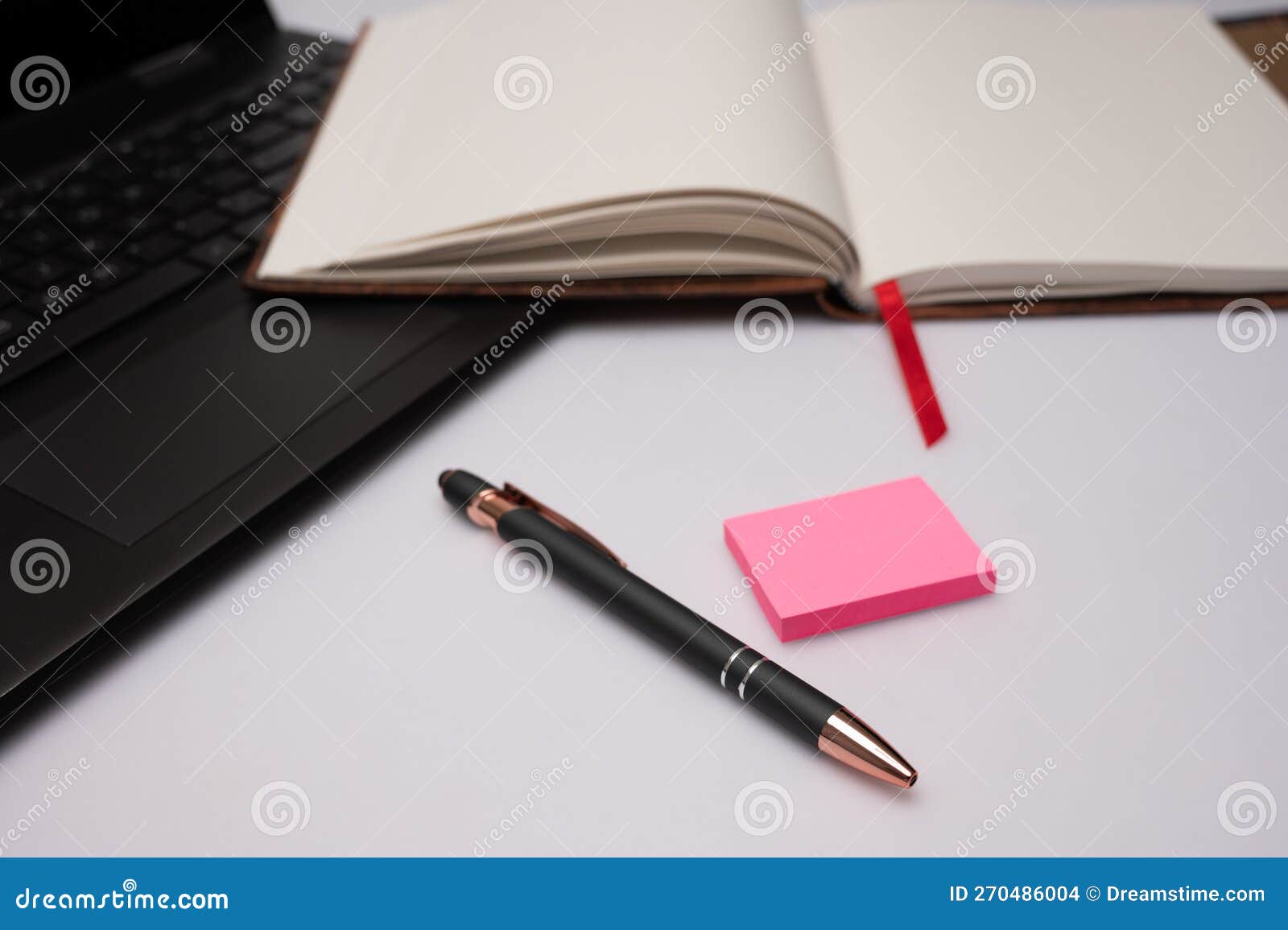 An Opened Notebook with a Laptop and Pen on a Desktop. Stock Photo ...