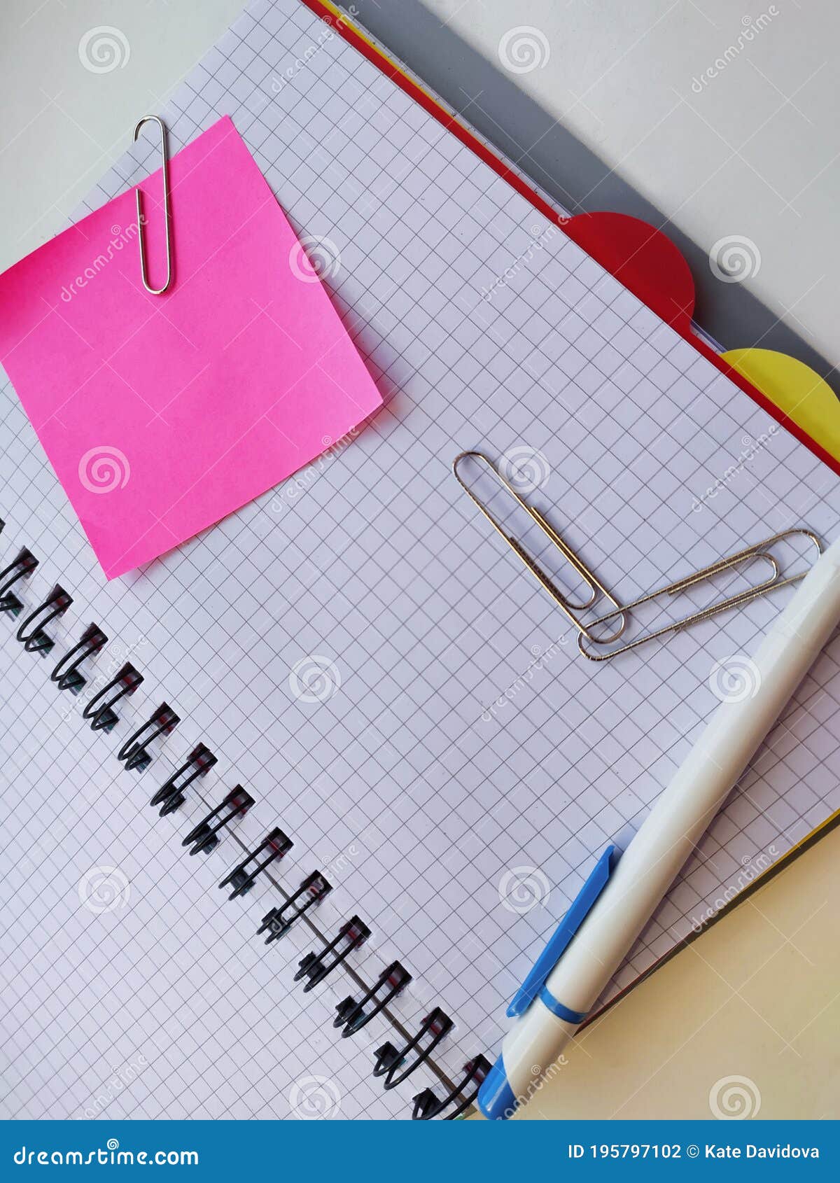 Opened Notebook, Pink Note Paper, Several Paper Clips and a White Pen ...