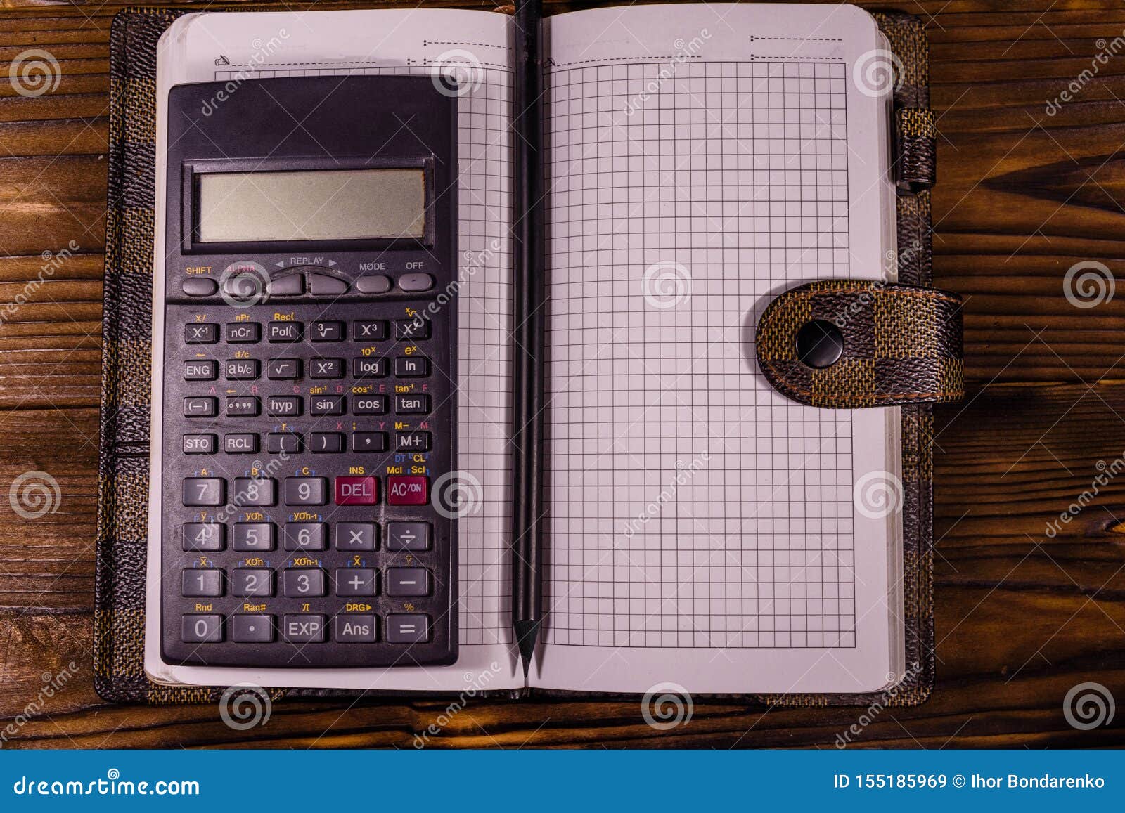 Opened Notepad, Scientific Calculator and Pencil on Wooden Table. Top ...