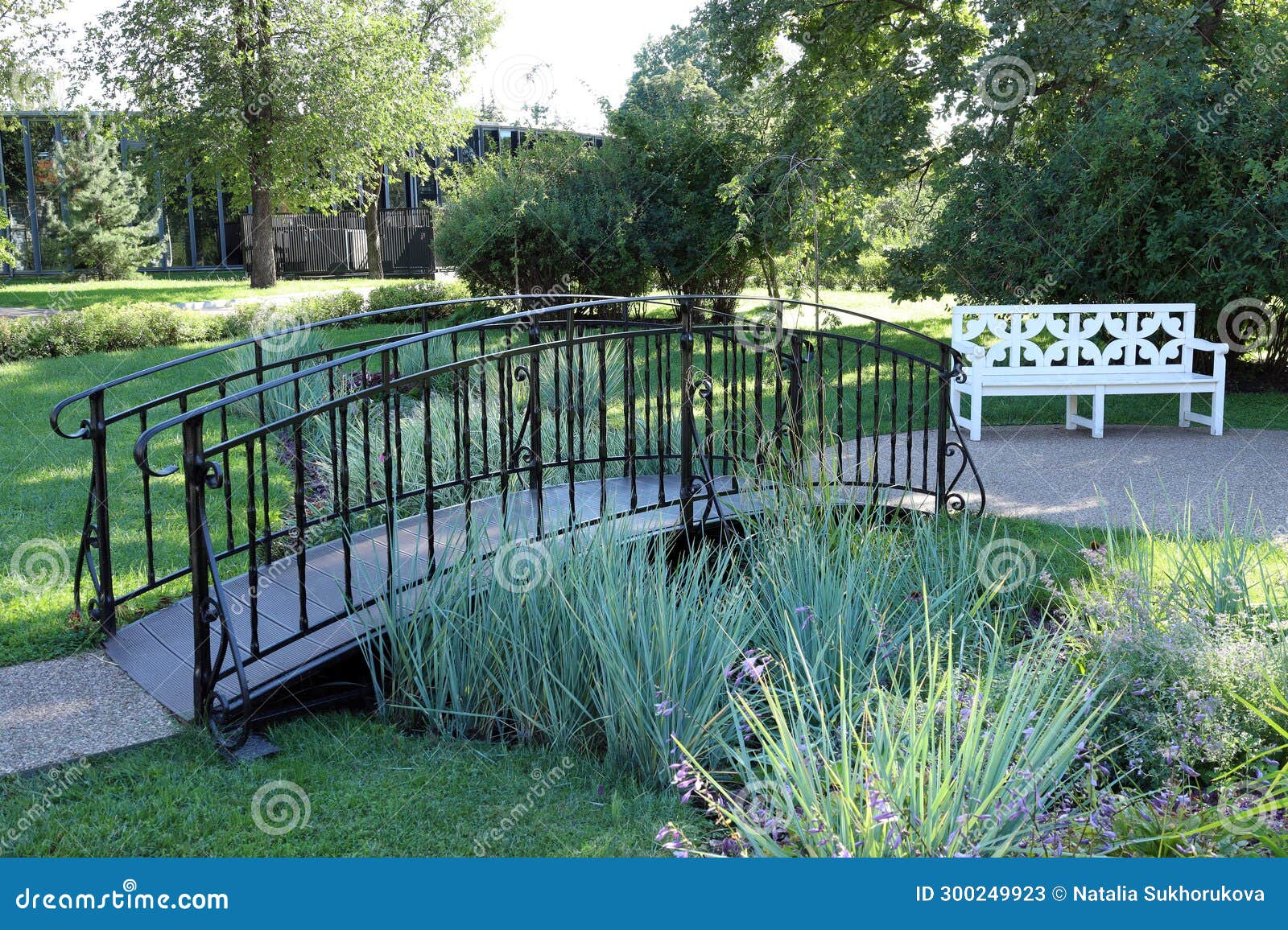 An Openwork Bridge Over a Dry Stream and a Bench for Relaxing in the ...