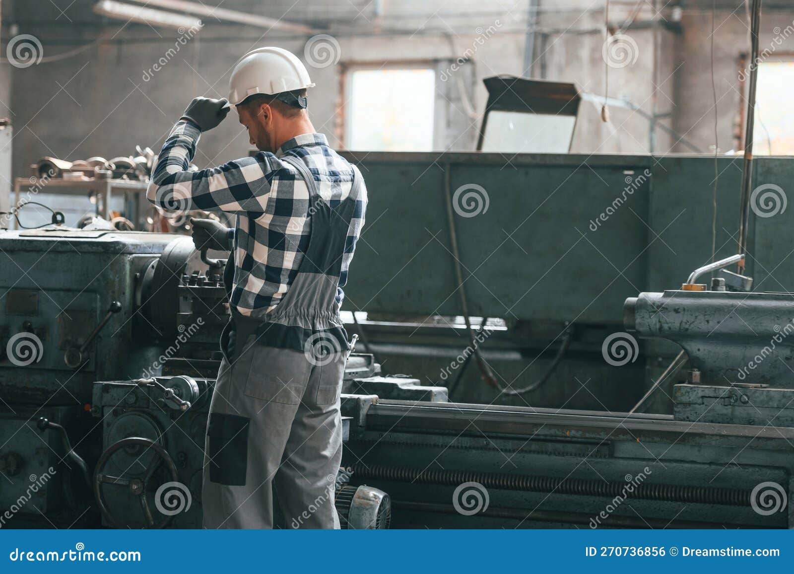 Operating Machine. Factory Male Worker in Uniform is Indoors Stock ...