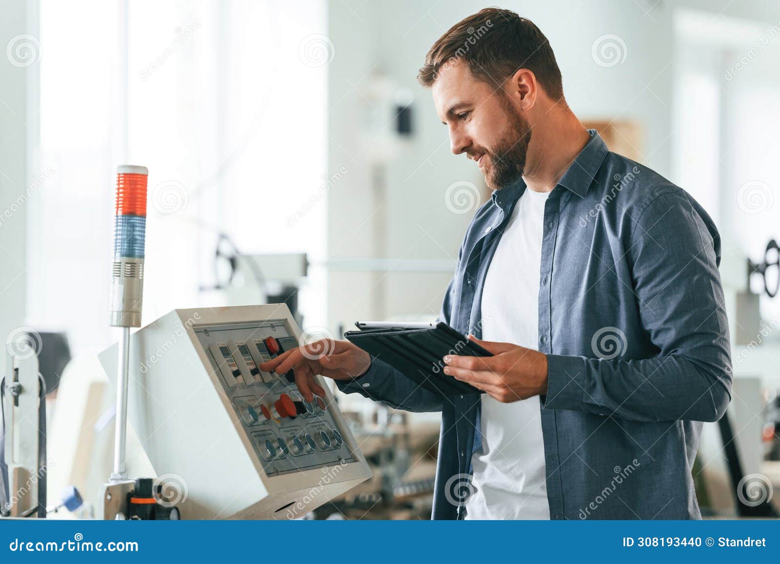 Operating the Machine. Handsome Man is Working at the Factory of ...