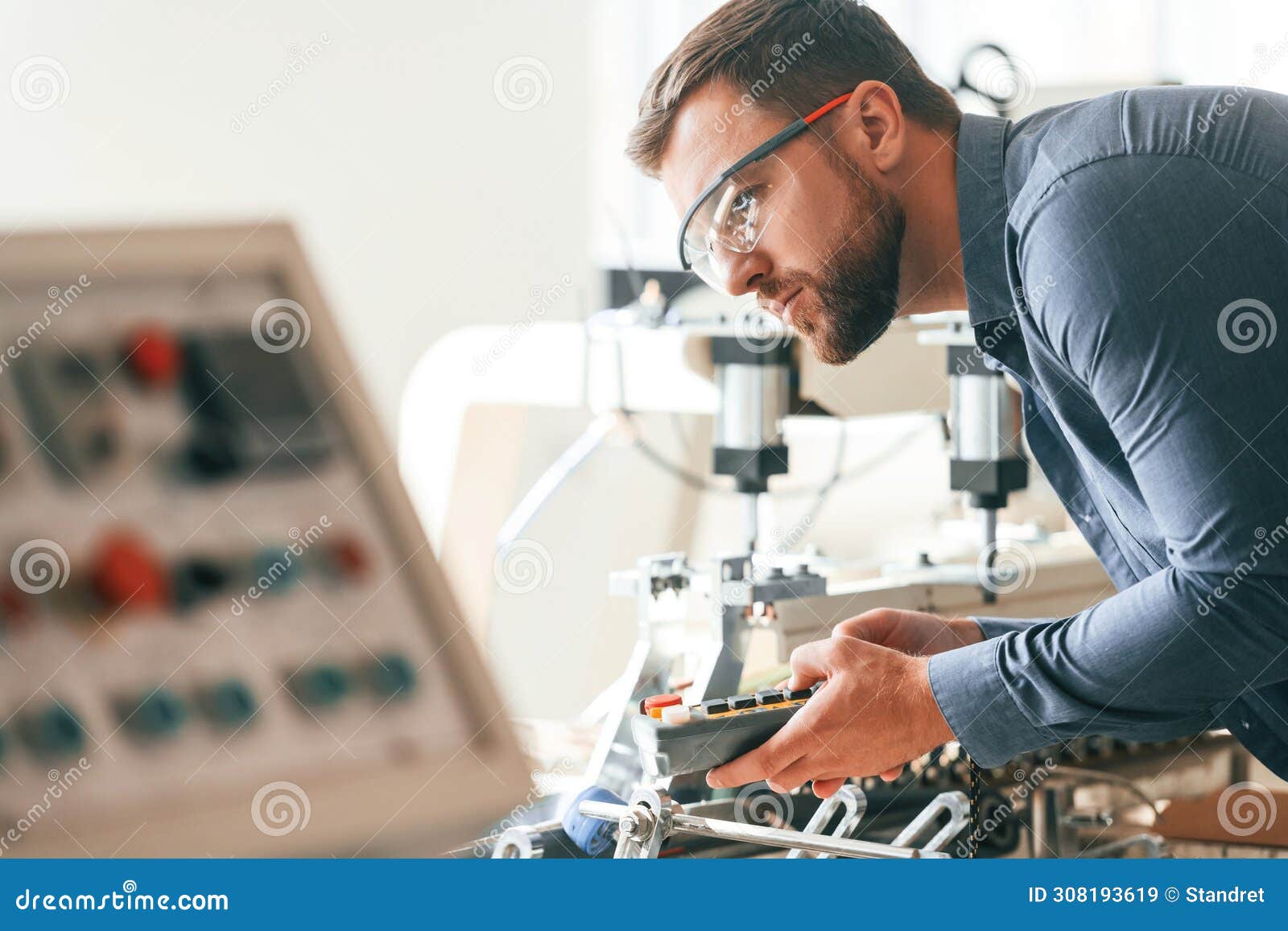 Operating the Machine. Handsome Man is Working at the Factory of ...