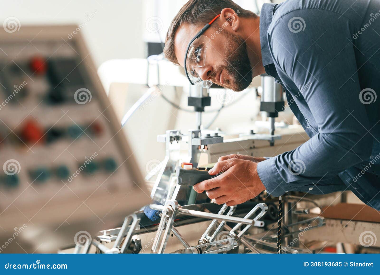 Operating the Machine. Handsome Man is Working at the Factory of ...